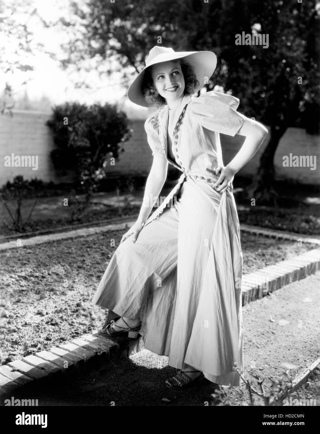 June Lang wears a turquoise blue sailcloth gardening outfit, 1937 ...