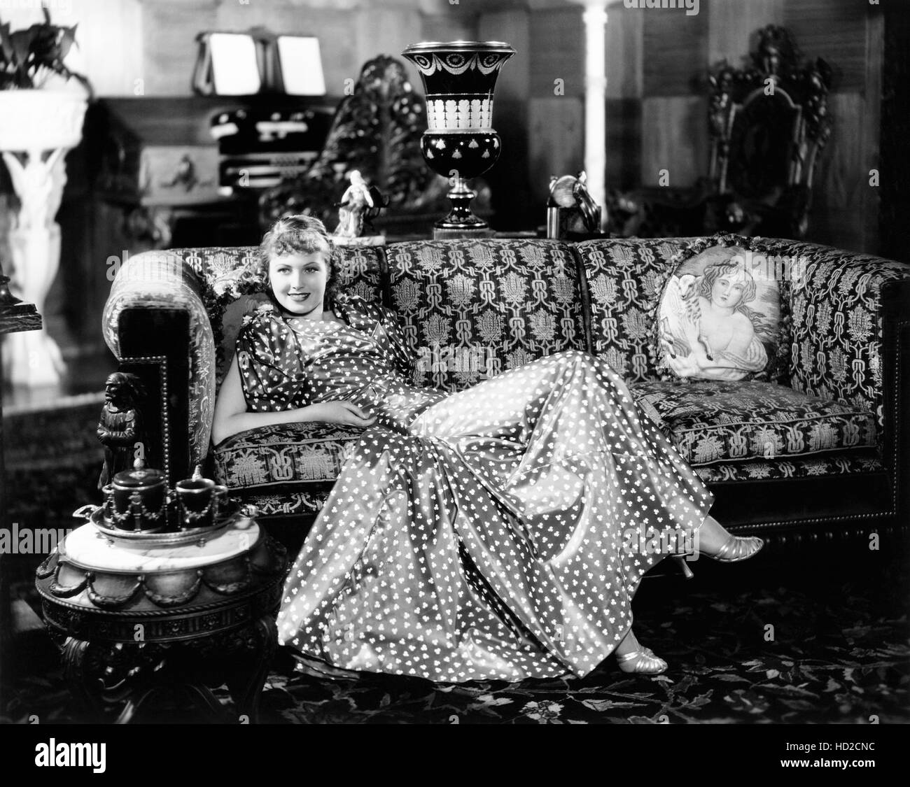 June Lang wears a violet taffeta leaf-print dress with bouffant details ...