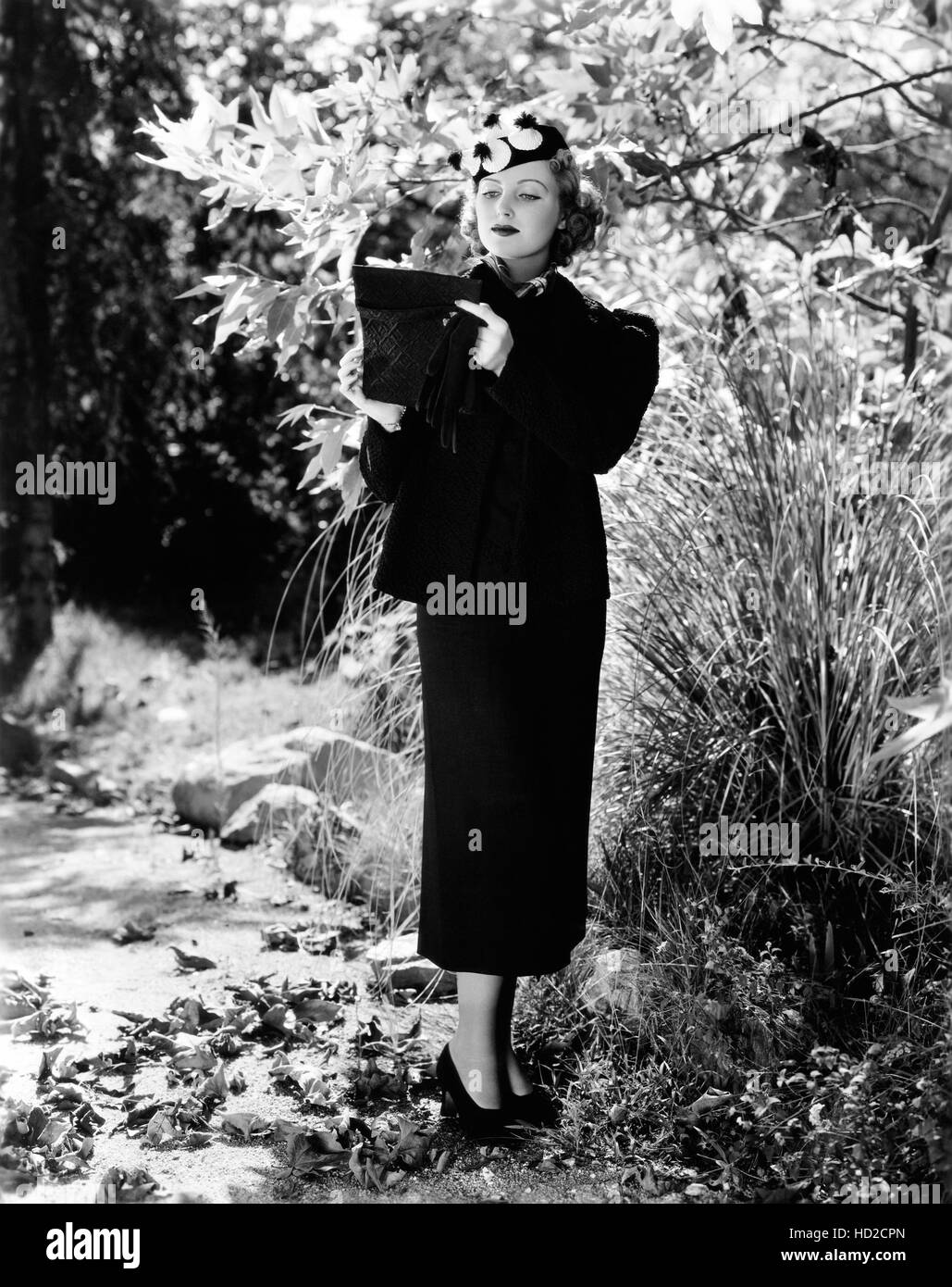 June Lang wearing a boxy wool jacket over black wool dress, 1936. ©20th ...