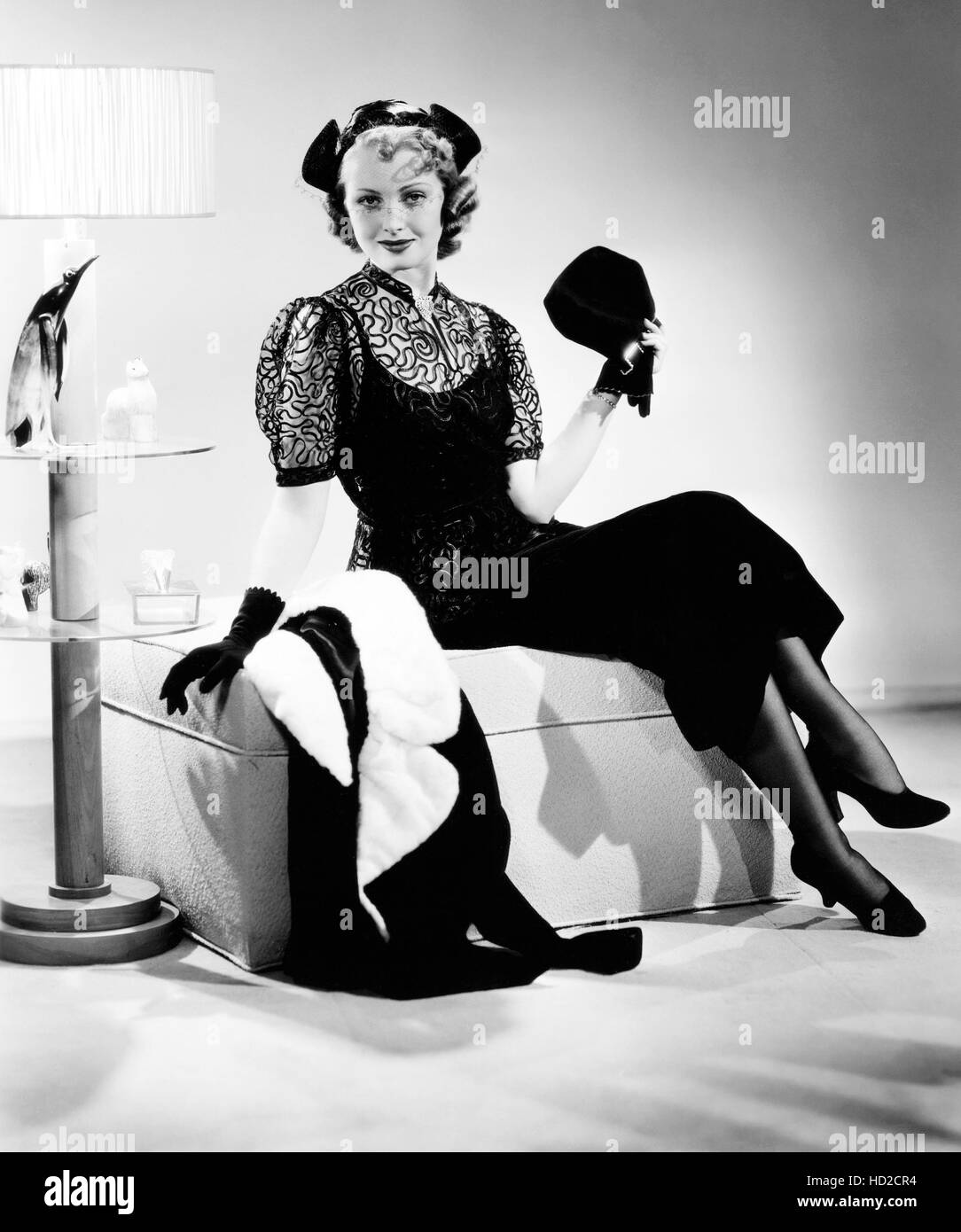 June Lang wears a velvet suit with blouse trimmed in scrolled soutache ...