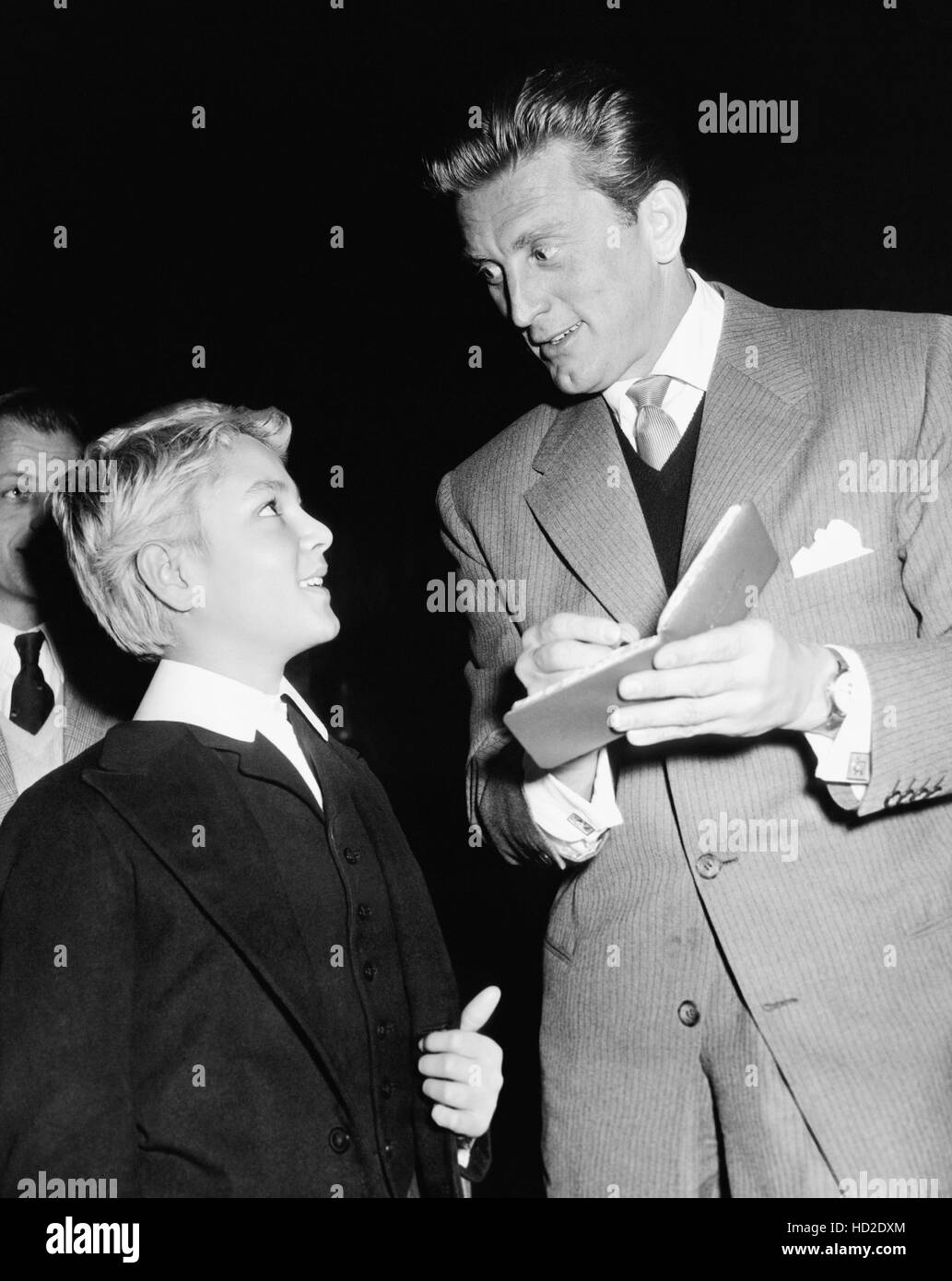 Kirk Douglas, right, signing autograph for British child actor Jeremy ...