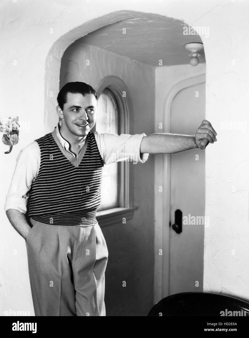 Lyle Talbot posing at the entrance of his Beverly Hills mansion, ca ...