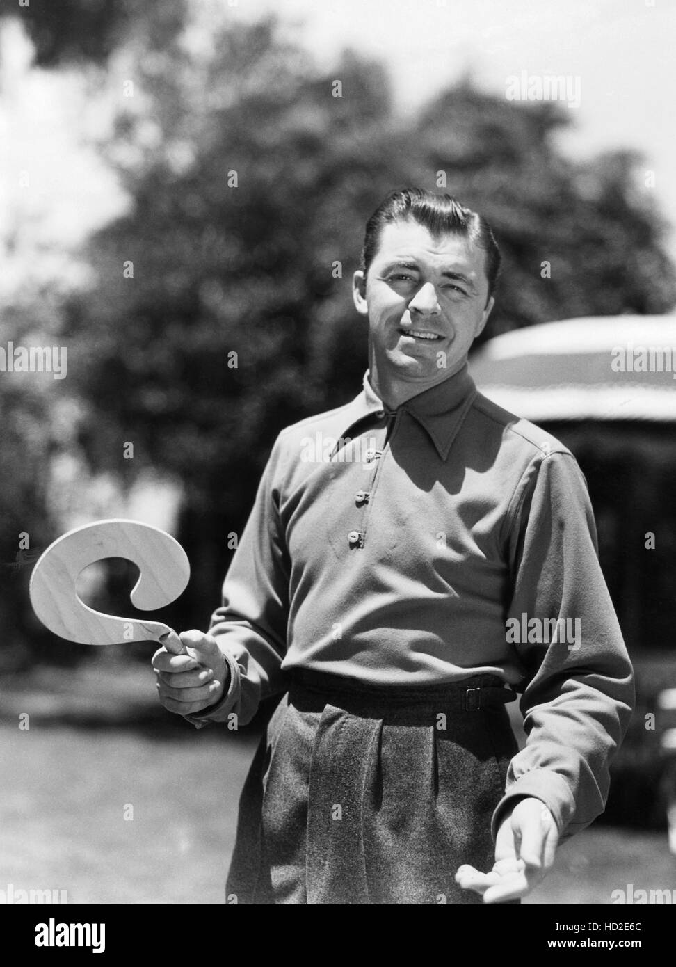 Lyle Talbot trying out boomerang in his back yard, 1935 Stock Photo - Alamy