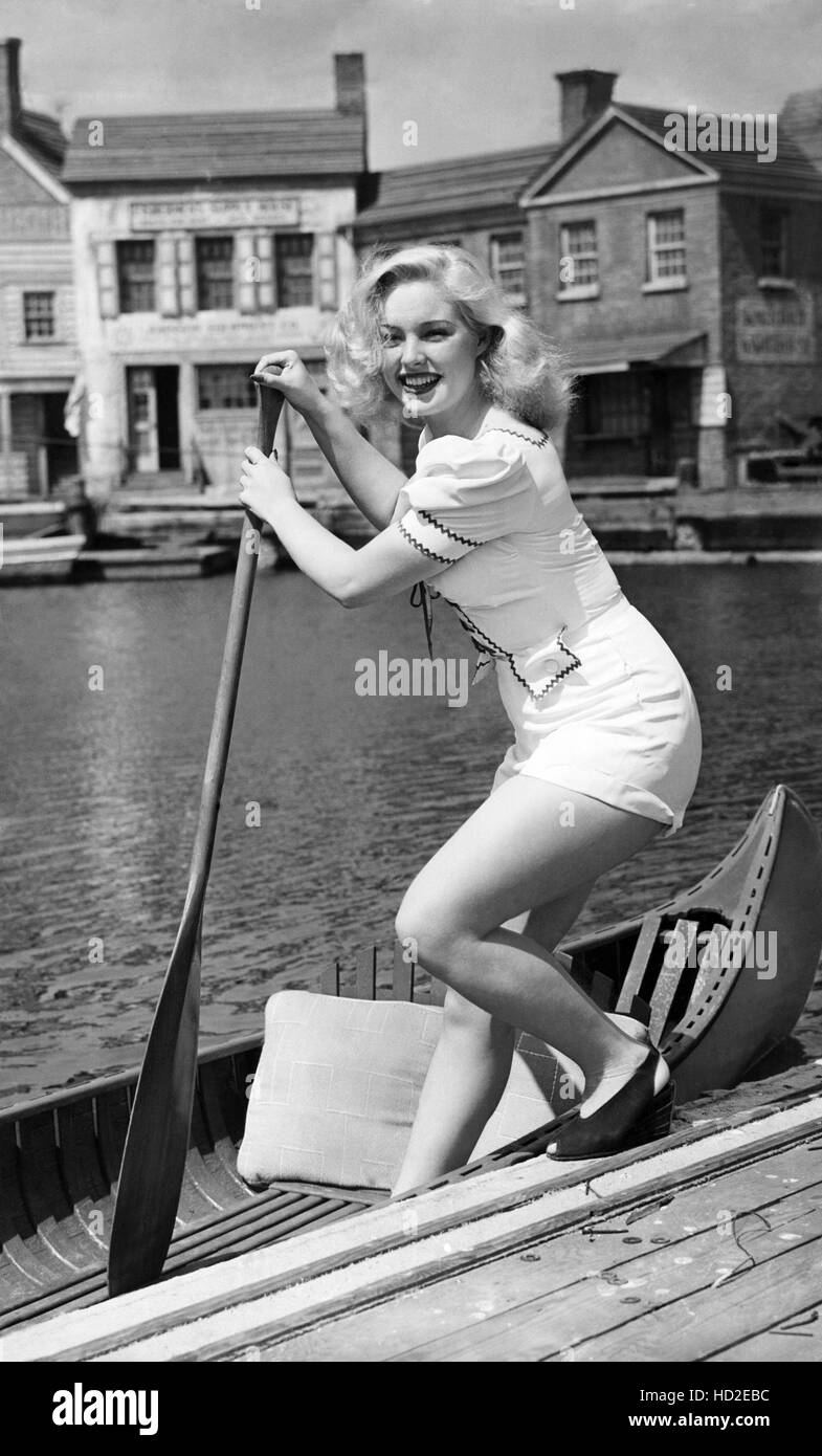 Mary Beth Hughes paddling canoe on back lot lake, ca. 1940 Stock Photo ...