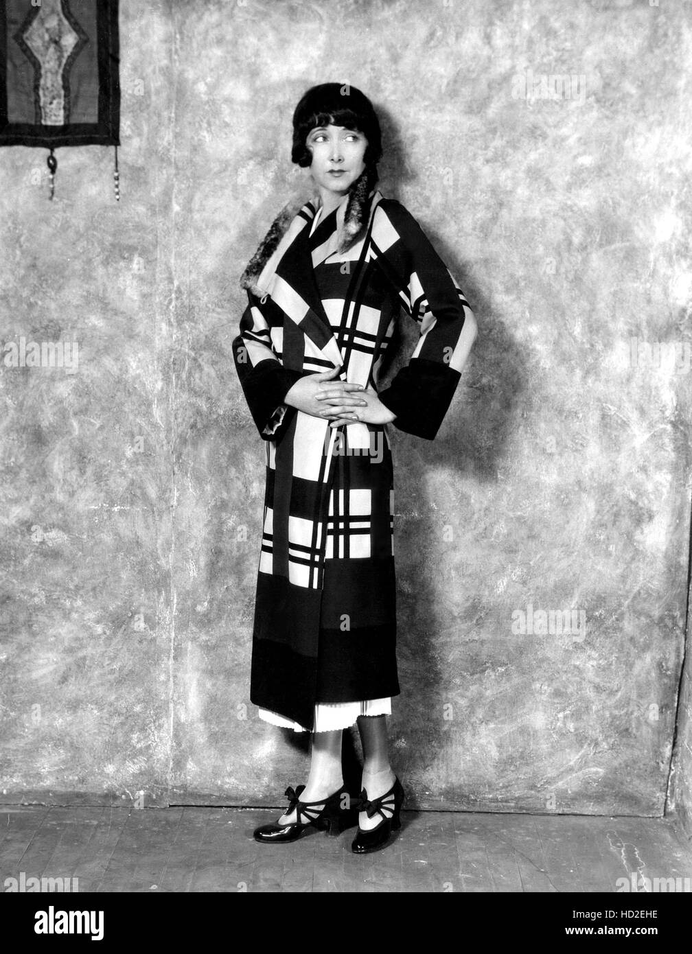 Mae Busch, wearing a plaid coat, the collar edged with fur, 1925 Stock ...