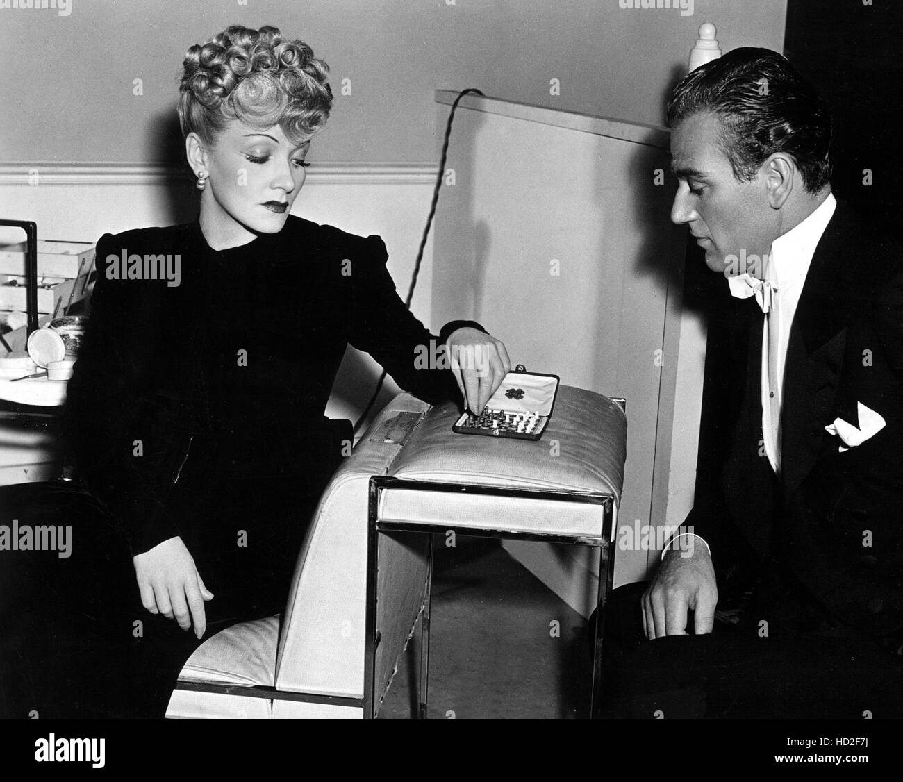 PITTSBURGH, Marlene Dietrich, John Wayne playing chess on set, 1942 ...