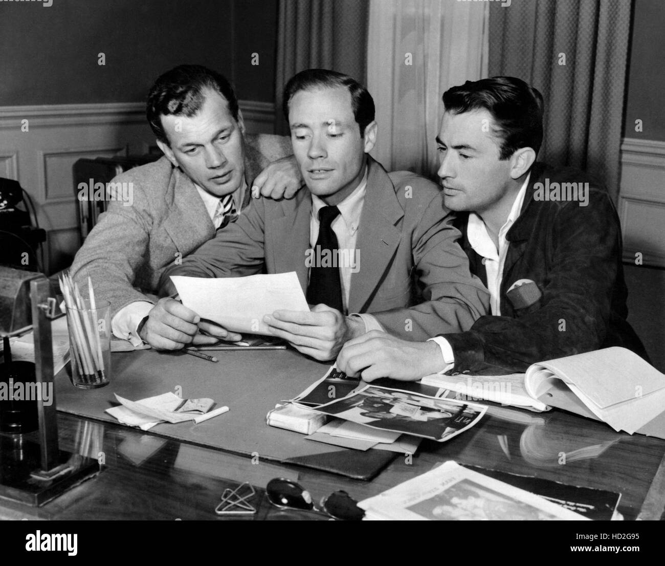 Mel Ferrer (center) confers with Joseph Cotten (left) and Gregory Peck ...