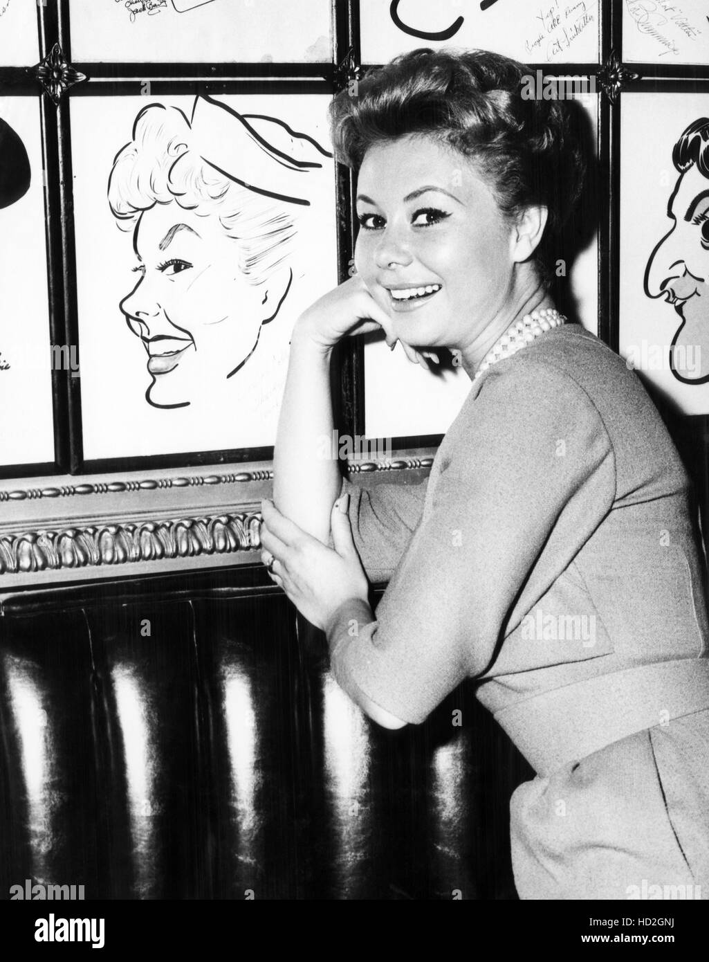 Mitzi Gaynor poses by her likeness at Hollywood's Brown Derby, 1959 ...