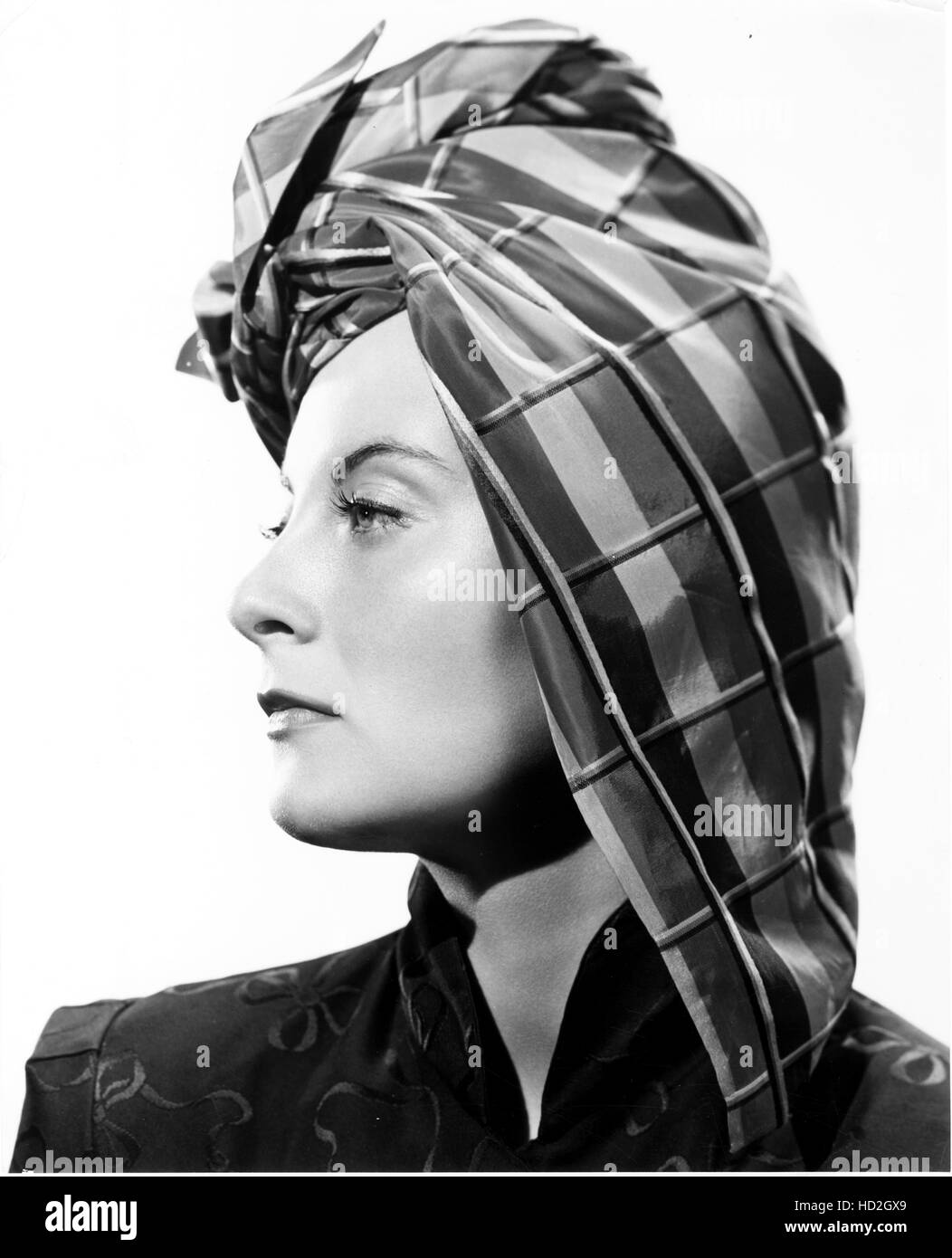 Michele Morgan, modeling a plaid silk hat, spring 1941 Stock Photo - Alamy