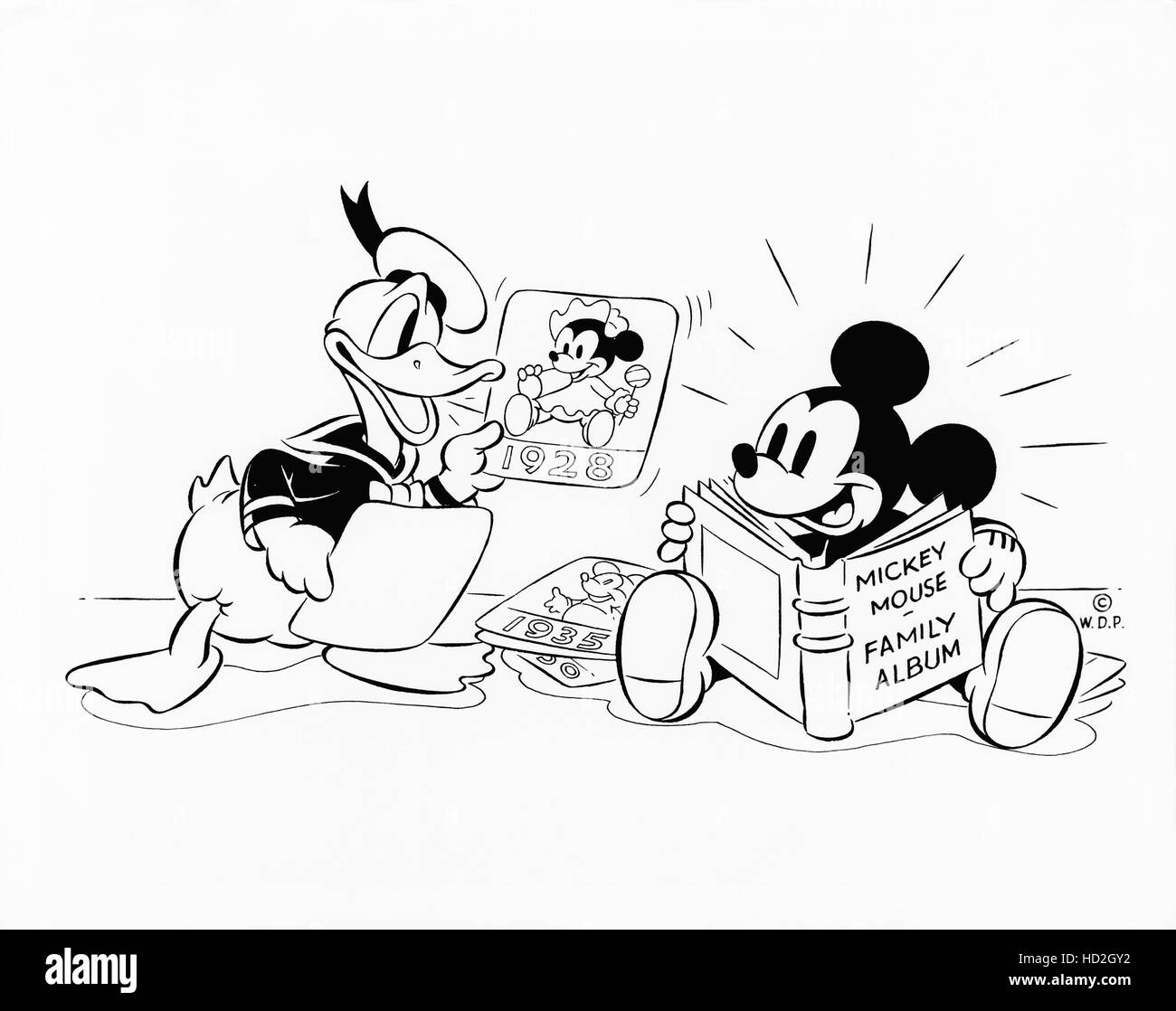 Donald Duck holds Mickey Mouse's baby picture in a publicity shot in ...