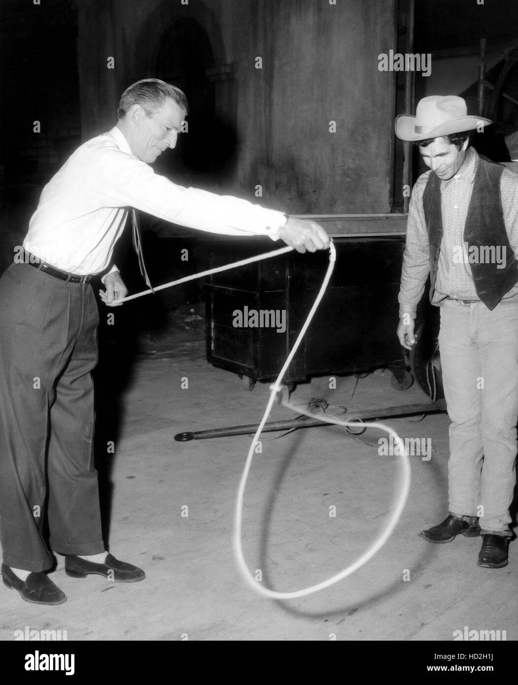 From left: Michael Rennie practicing rope twirling with the help of ...
