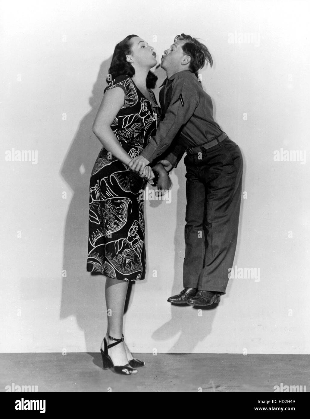 Mickey Rooney attempts to kiss 'Glamazon' Dorothy Ford on the MGM set ...
