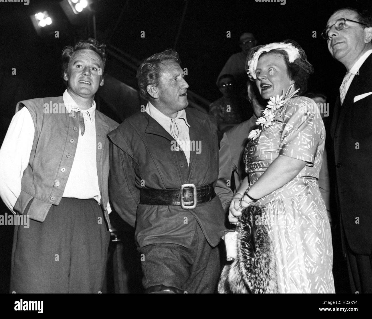 VAN JOHNSON, SPENCER TRACY and producer DORE SHARY welcome a visitor to ...