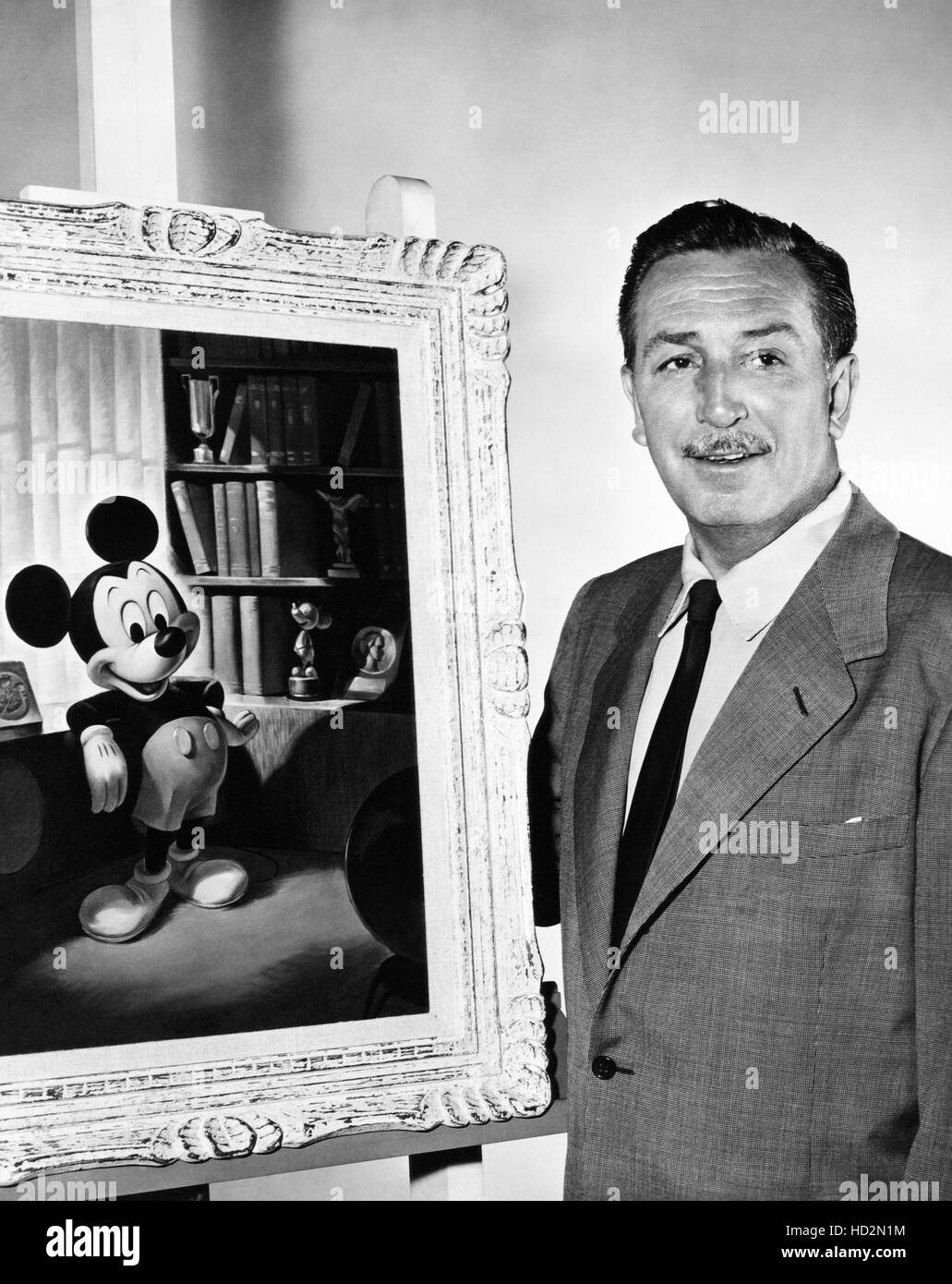 Walt Disney with framed portrait of Mickey Mouse on the occasion of ...