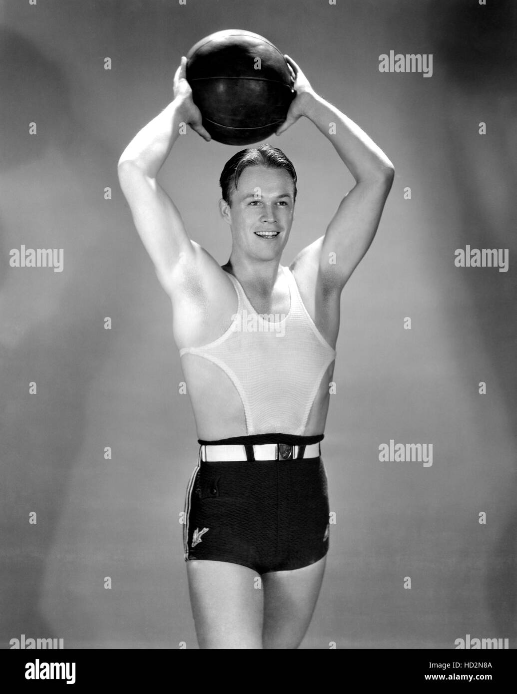 Wayne Morris posing with medicine ball, ca. 1937 Stock Photo - Alamy
