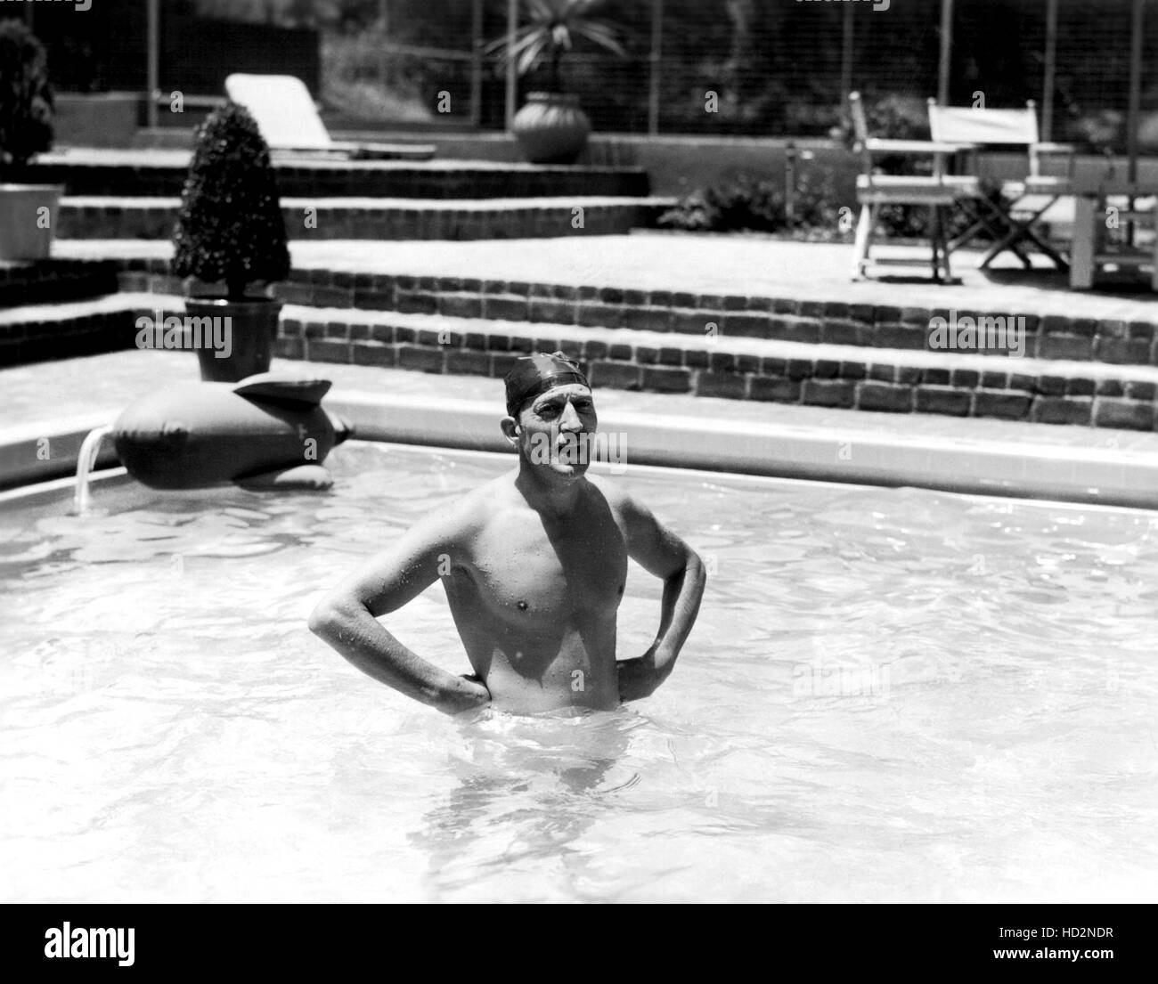 Warren William in swimming pool at his home, ca. 1936 Stock Photo - Alamy