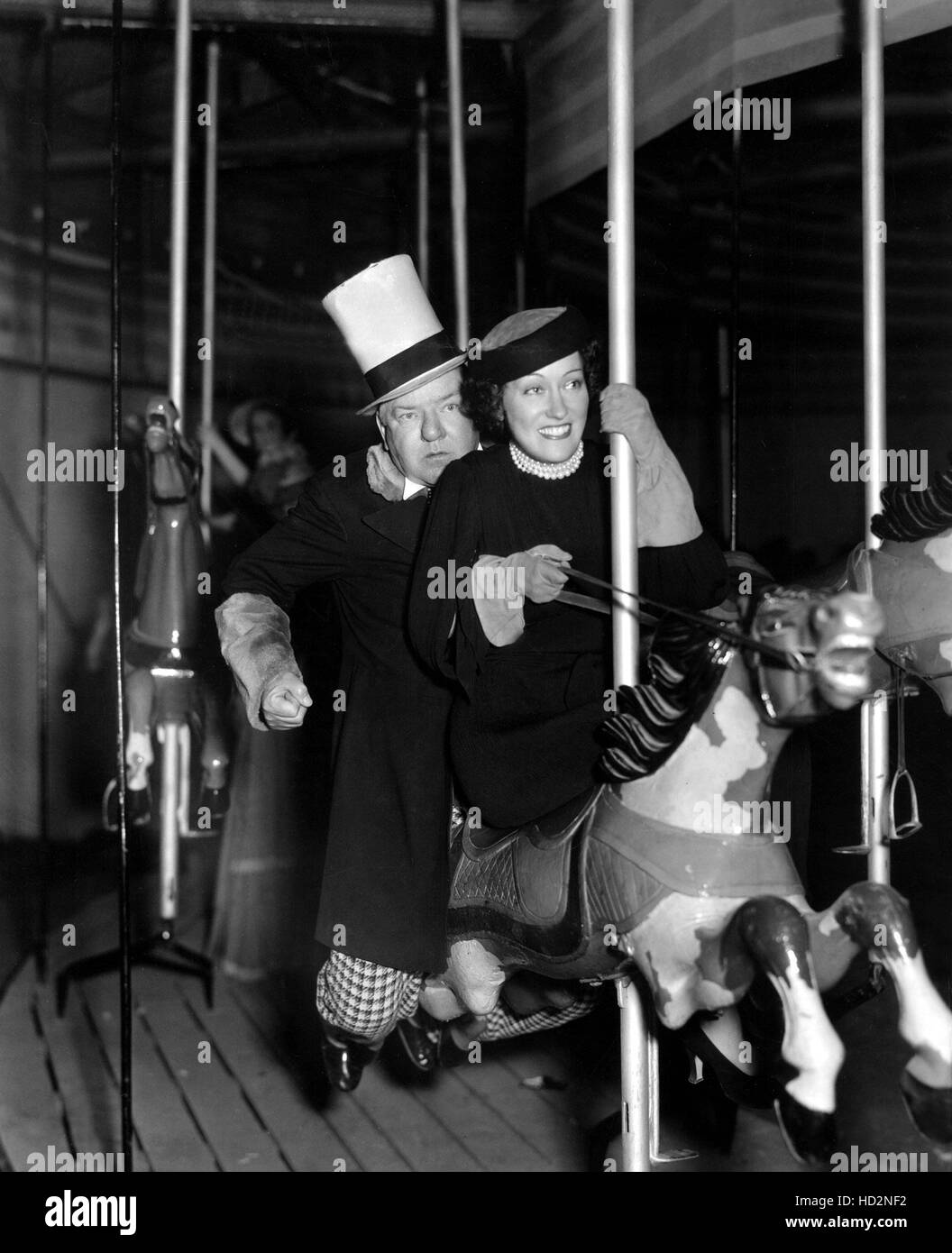 W.C. FIELDS and GLORIA SWANSON ride the carousel constucted for Paramount's POPPY, 1936 Stock ...