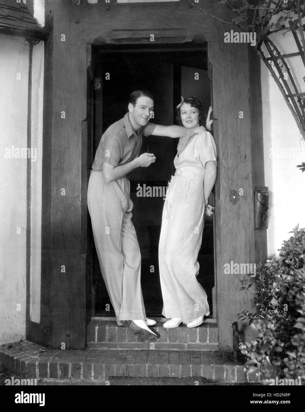 From left: William Gargan, Mary Gargan standing in doorway of their Hollywood home, ca. 1935 ...