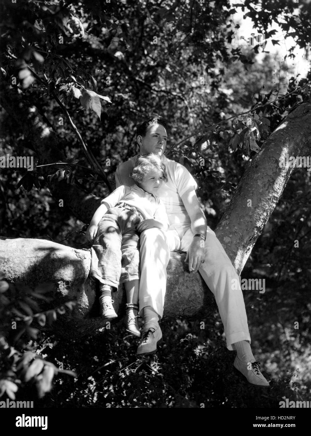 From left: Barry Gargan and his father, William Gargan sitting in tree on the grounds of their ...