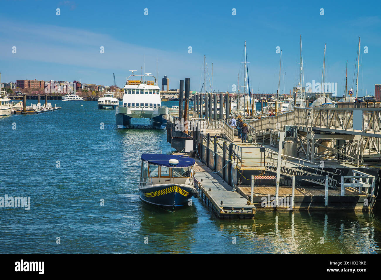 Pier of Boston Wharf and sail boats in Charles River, Boston ...
