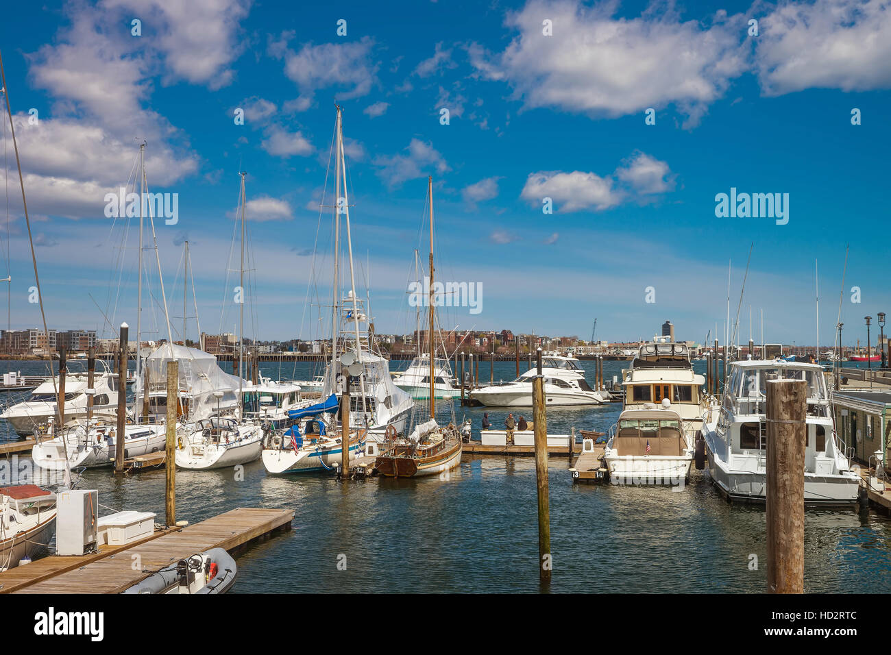 Pier of Boston Wharf with sail boats in Charles River, Boston ...
