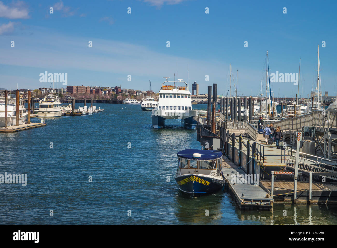 Pier of Boston Wharf with sailboat in Charles River, Boston ...