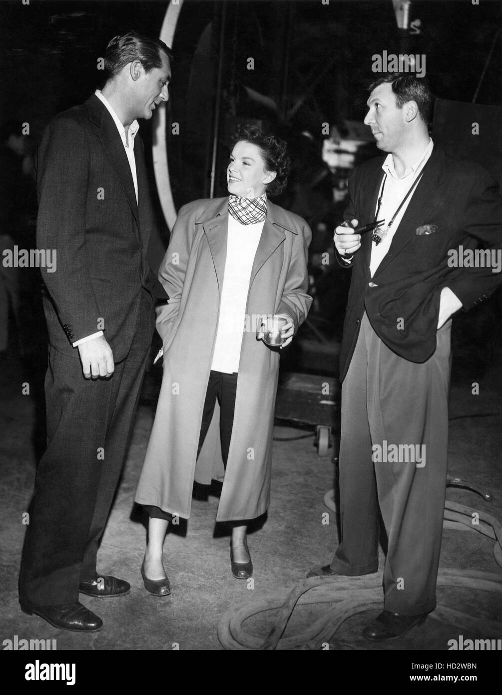 Director Richard Brooks (r) and Cary Grant receive a visit from Judy ...