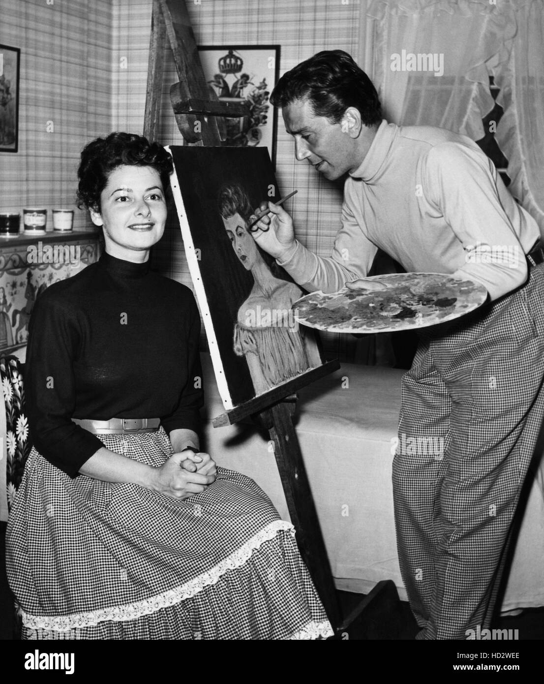 Richard Conte, painting his first wife, actress Ruth Storey, at home ...