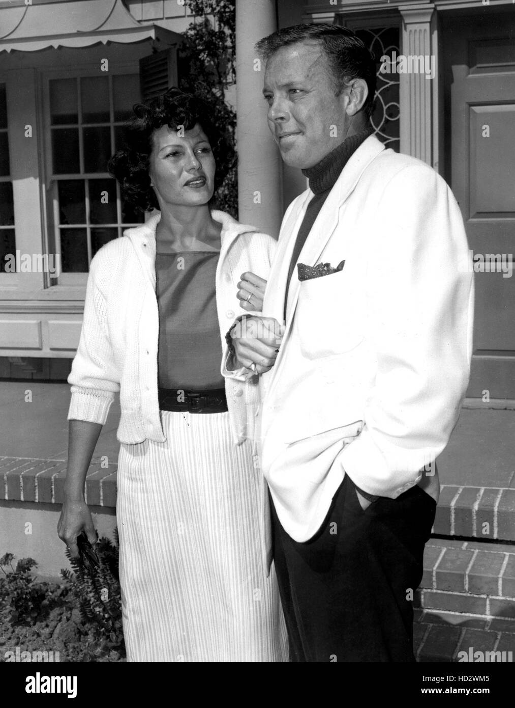 RITA HAYWORTH strolls with husband DICK HAYMES after a court decision ...