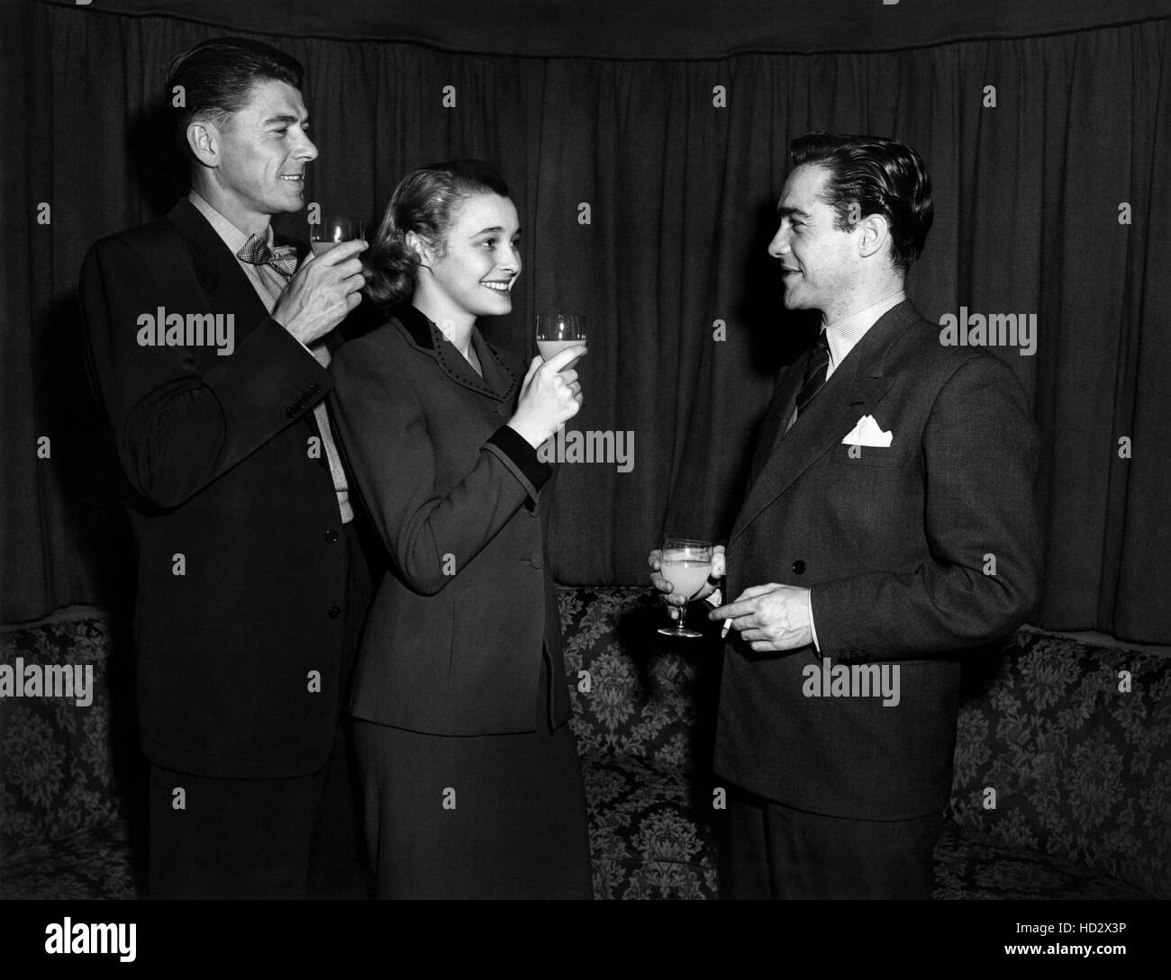 Ronald Reagan and Patricia Neal toast Richard Todd at party for THE ...