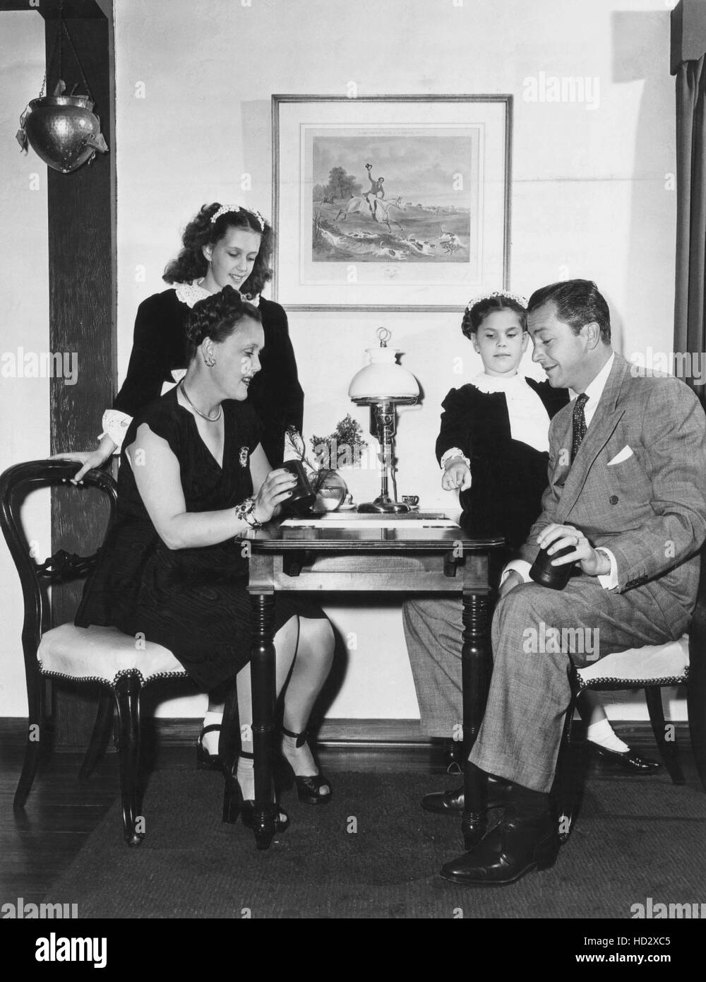 Wife and husband Betty Henderson Young and Robert Young play a board ...