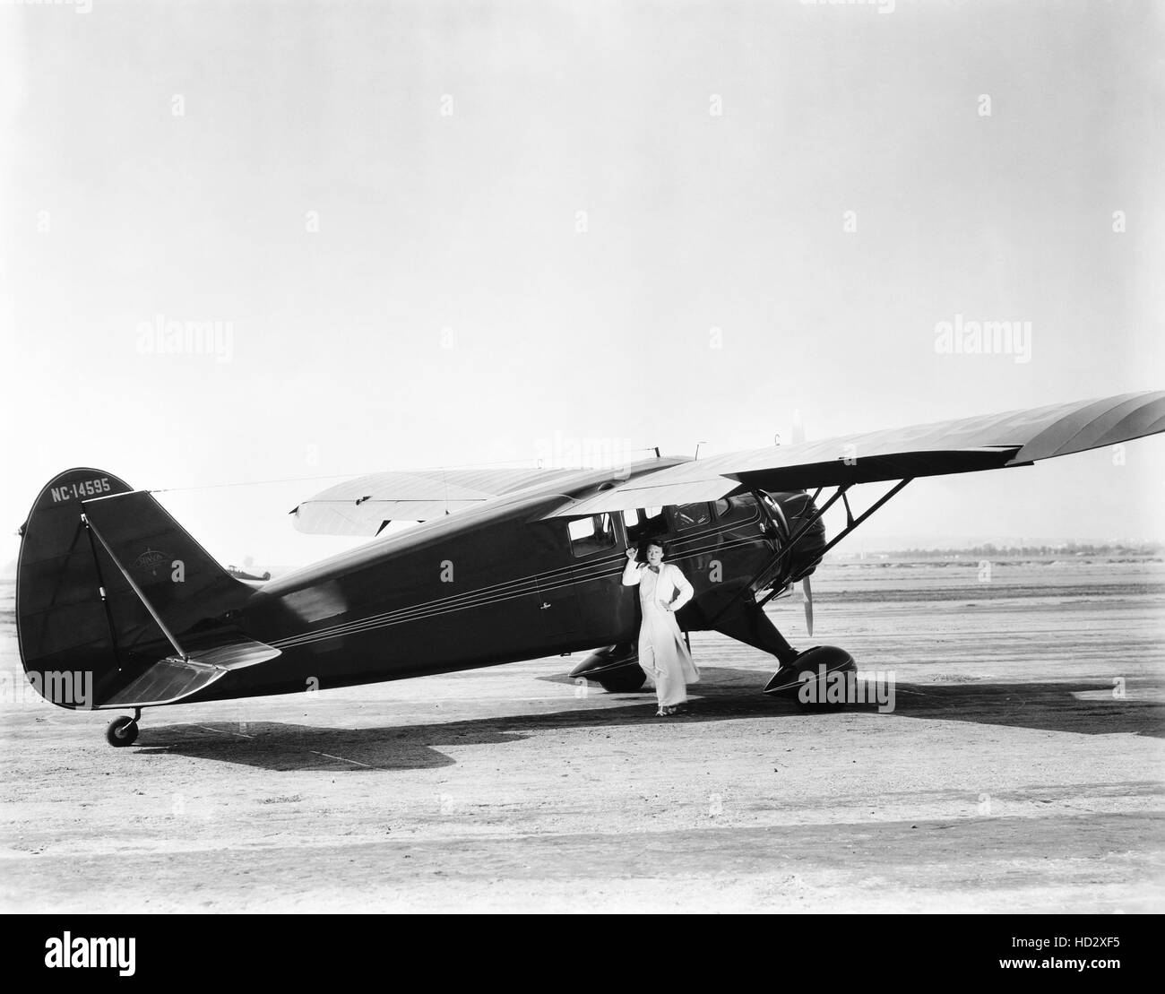 Ruth Chatterton standing by her Stinson airplane which she flew from ...