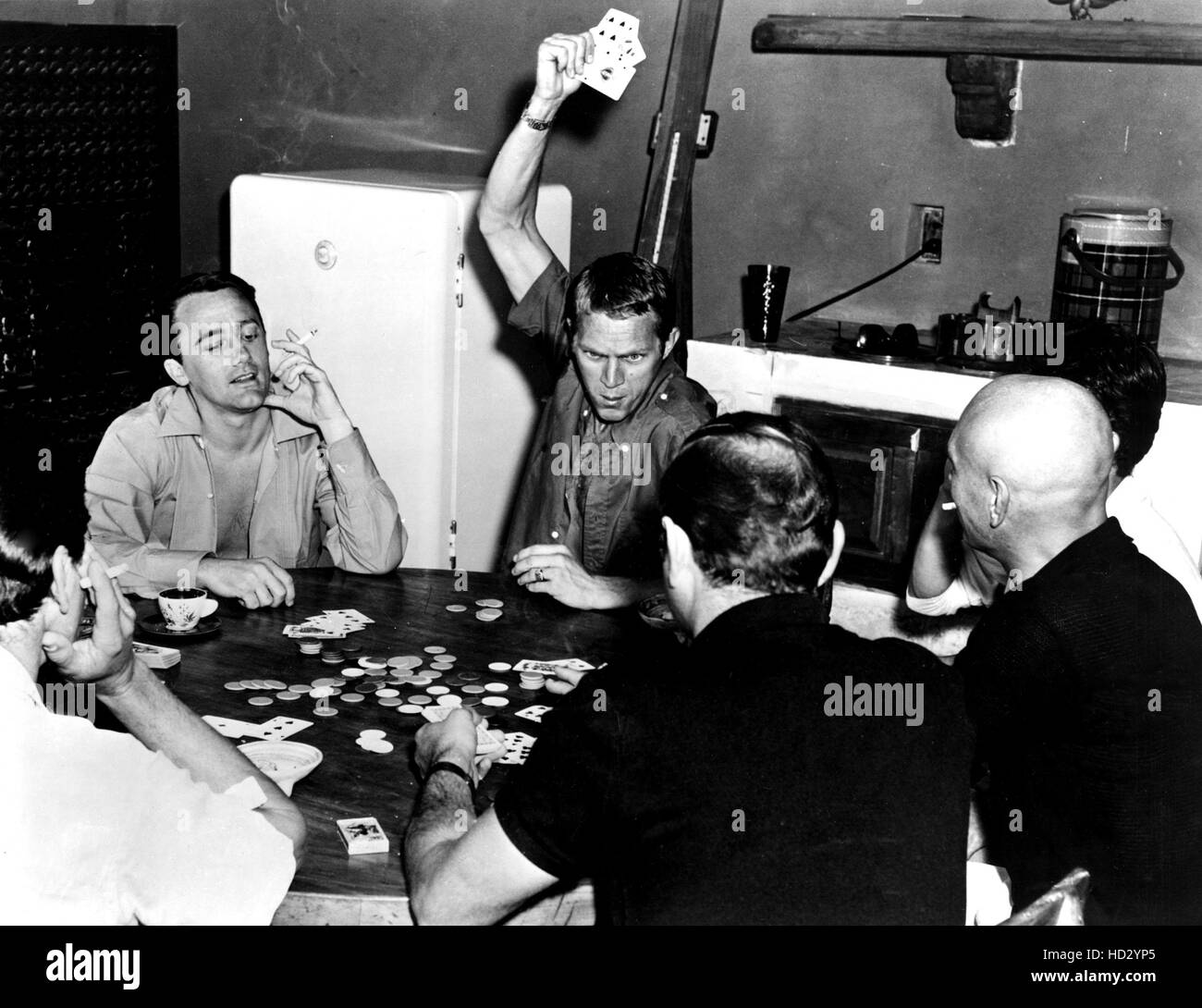 A defiant STEVE McQUEEN shows his winning hand during a MAGNIFICENT ...