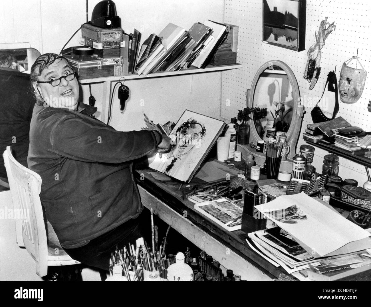 Zero Mostel pointing out self portrait at his studio, ca. early 1960s ...