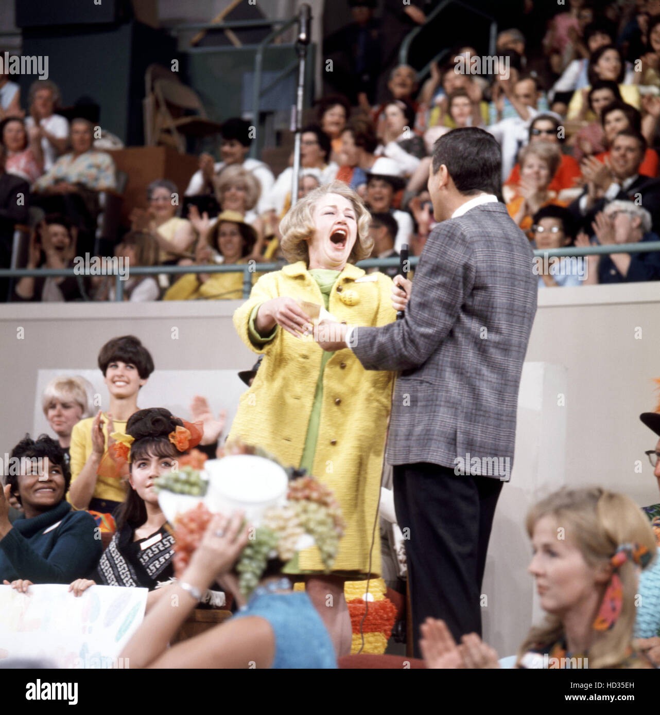 LET'S MAKE A DEAL, host Monty Hall (standing, right) with a contestant ...