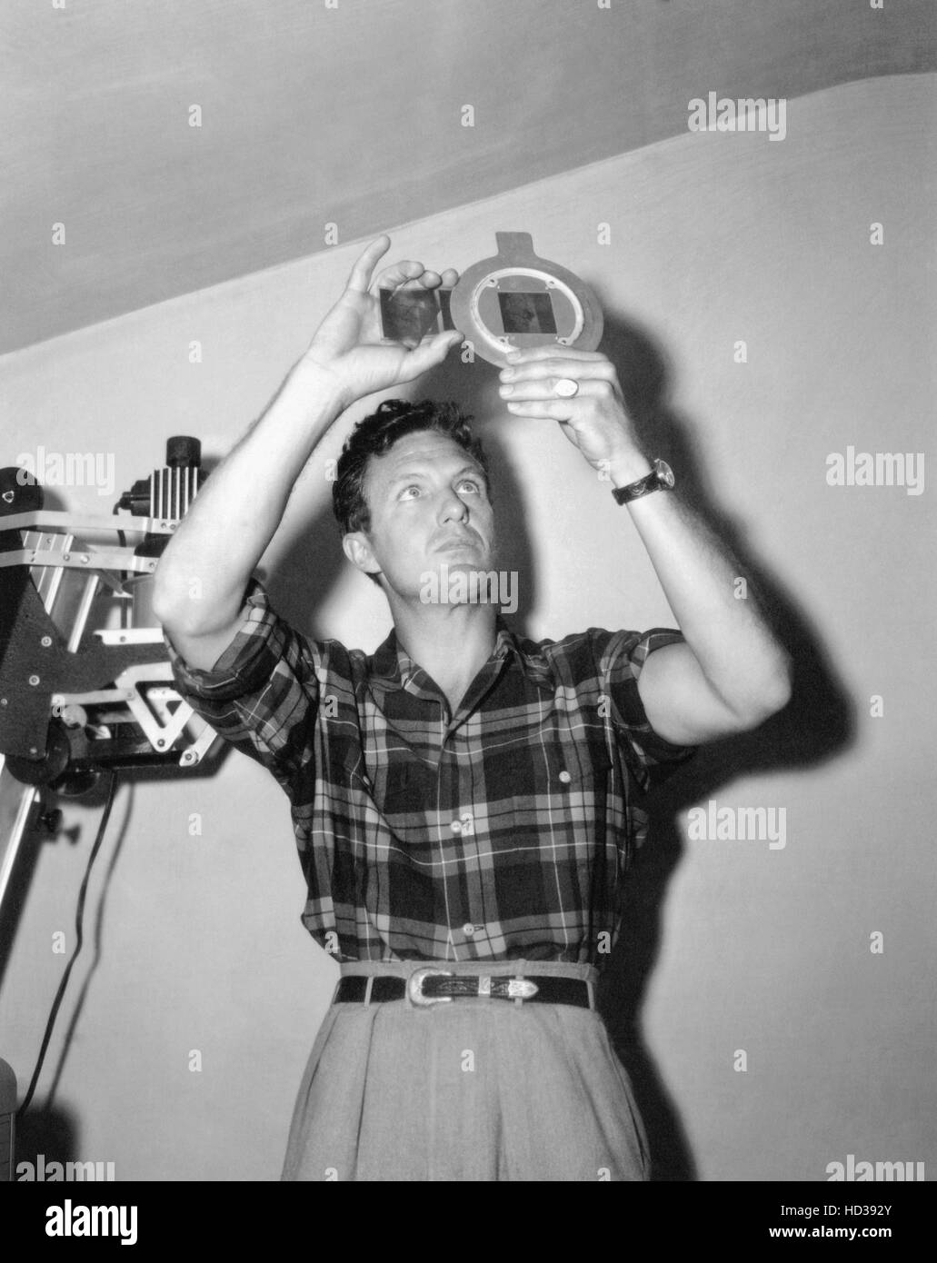 Robert Stack, examining negatives at home, 1954 Stock Photo - Alamy