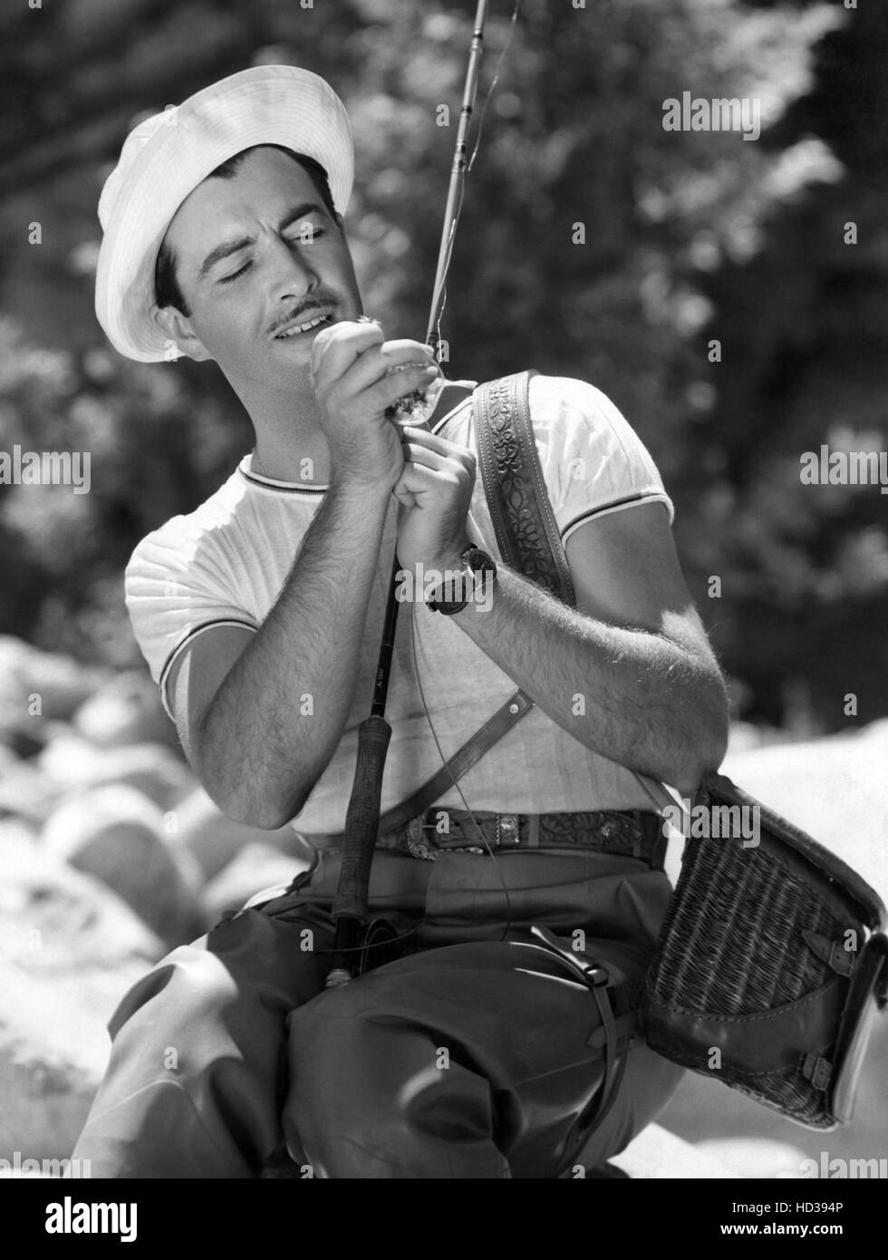 Robert Taylor fishing in the San Gabriel River while on vacation, ca ...