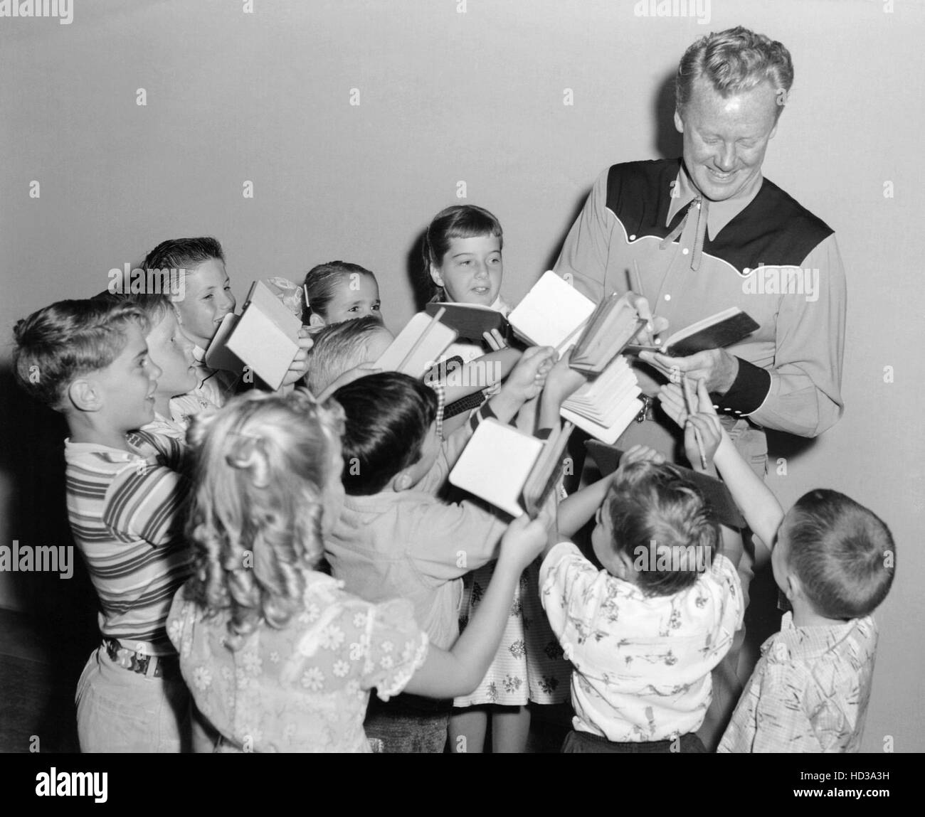 Van Johnson signing autographs for children from his daughter's school ...