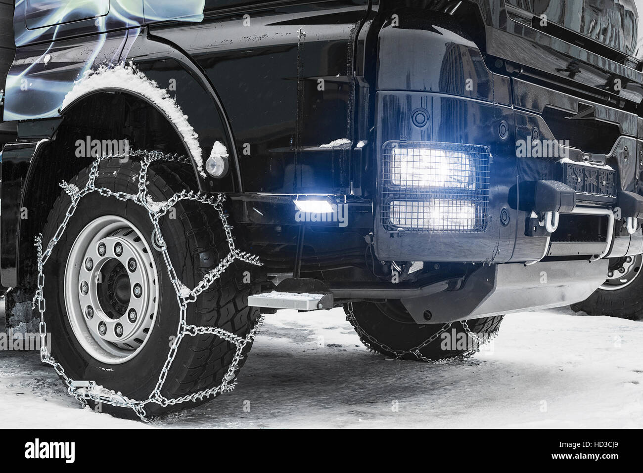 Wheel with chain and part of the truck Stock Photo - Alamy