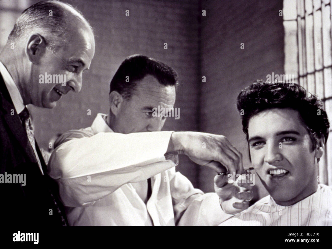 ELVIS PRESLEY gets a haircut, c. 1950s Stock Photo - Alamy