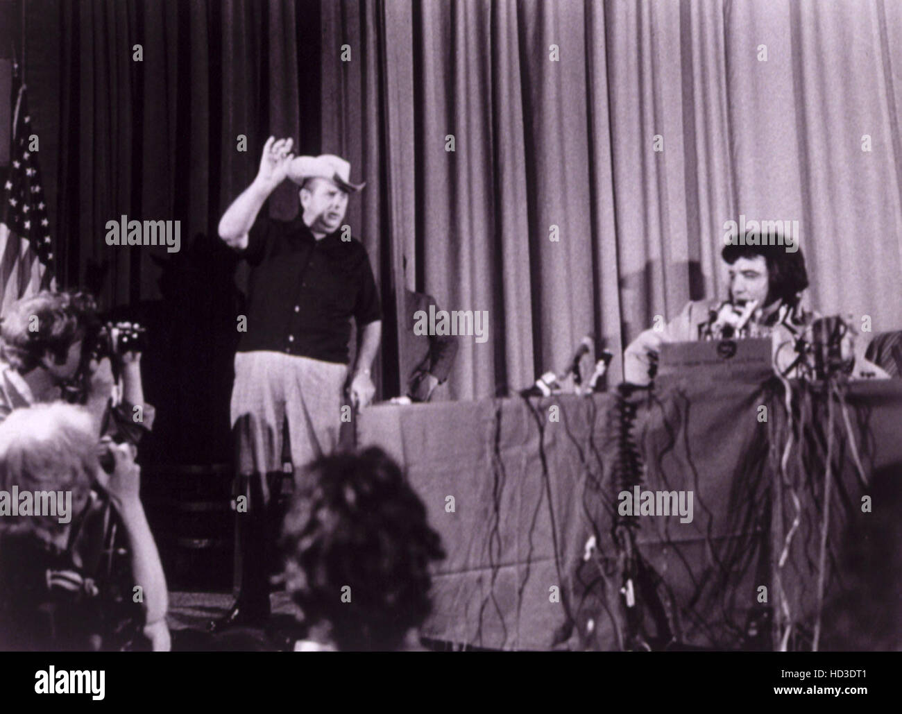 COLONEL TOM PARKER conducts a press conference with his star client ...