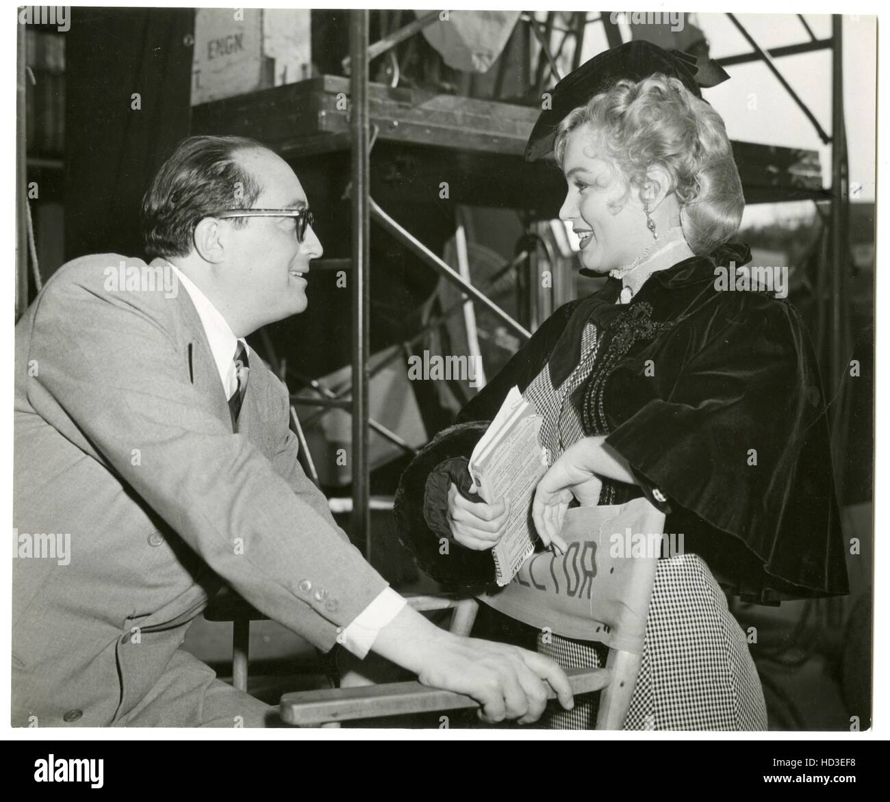 Director Henry Koster confers with Marilyn Monroe on the set of O ...
