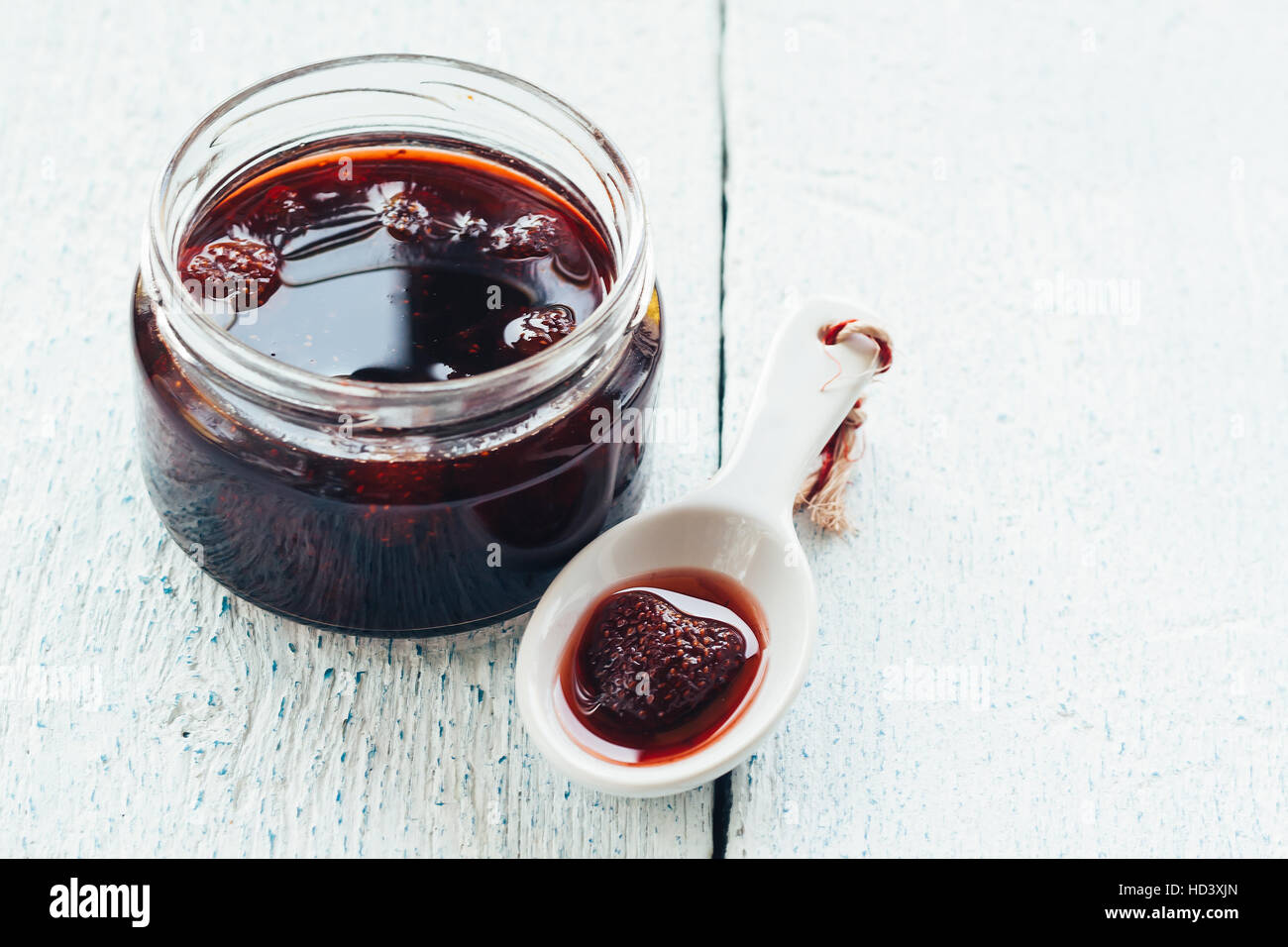 liquid strawberry jam in a jar with a spoon Stock Photo - Alamy