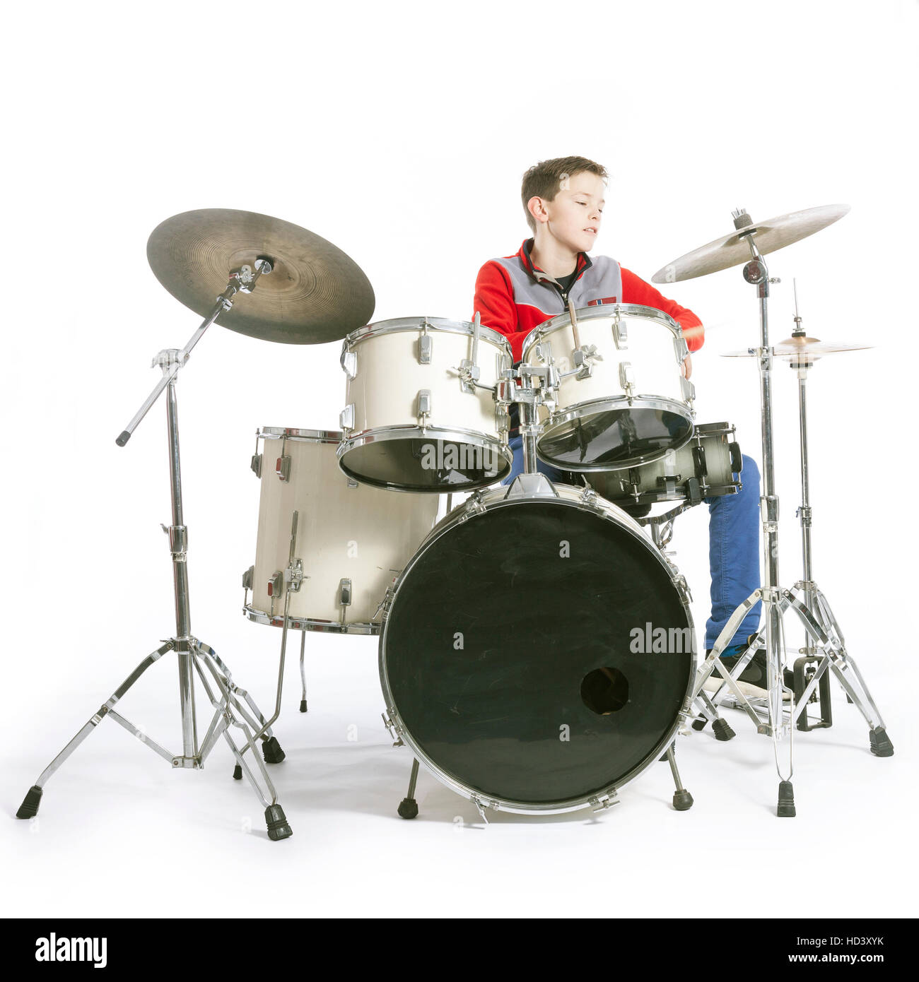 teenage caucasian boy plays drums in studio with white background Stock ...