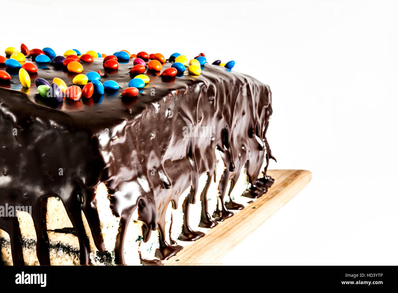 the cake watered chocolate and sprinkle with colored sprinkles isolated ...