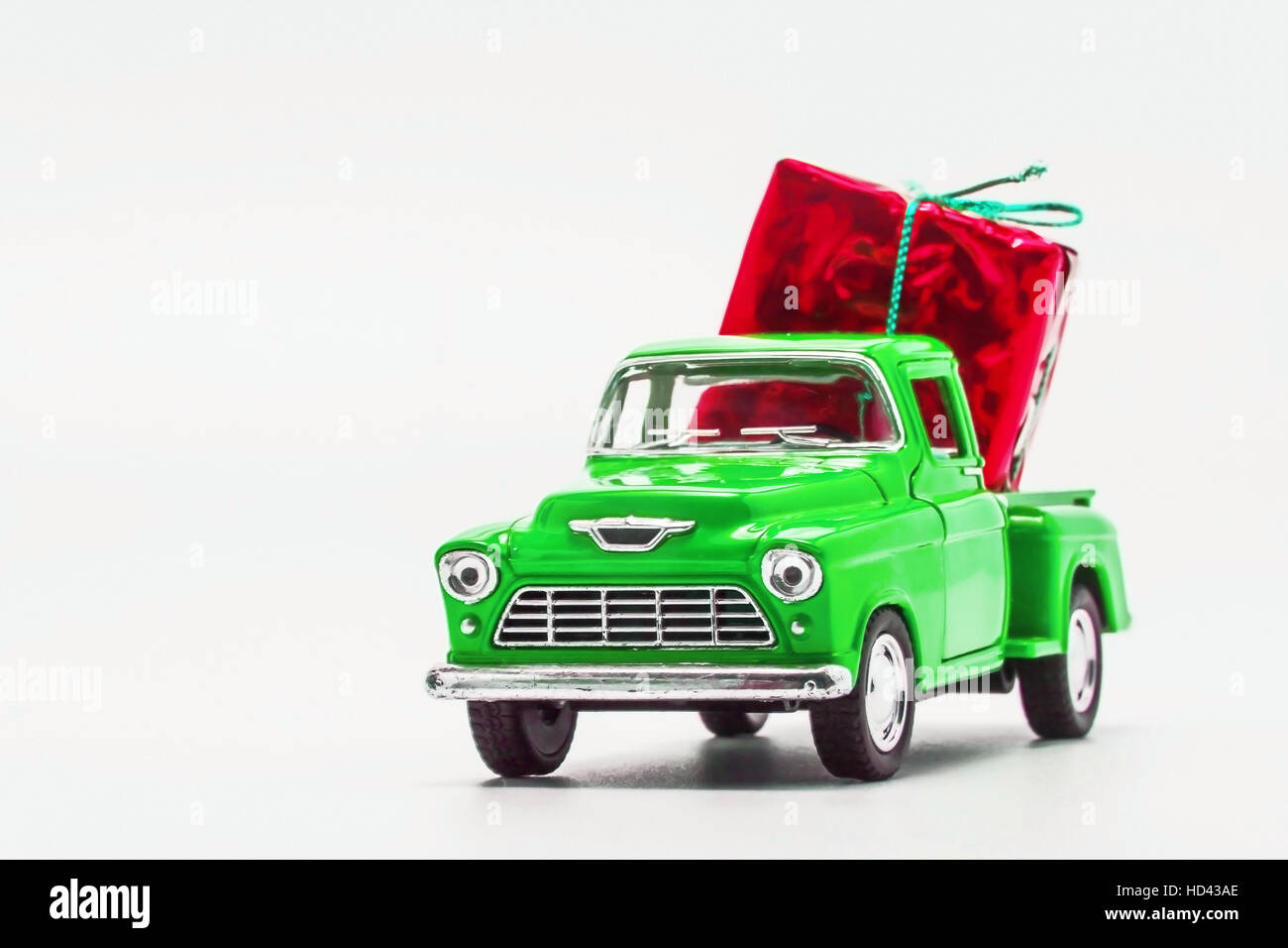 green retro car pickup with a red gift box isolated Stock Photo - Alamy