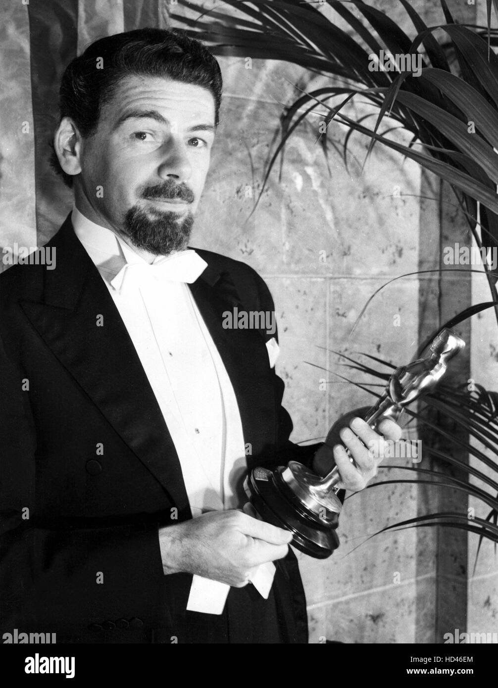 1936: PAUL MUNI [Best Actor, THE STORY OF LOUIS PASTEUR], poses with ...