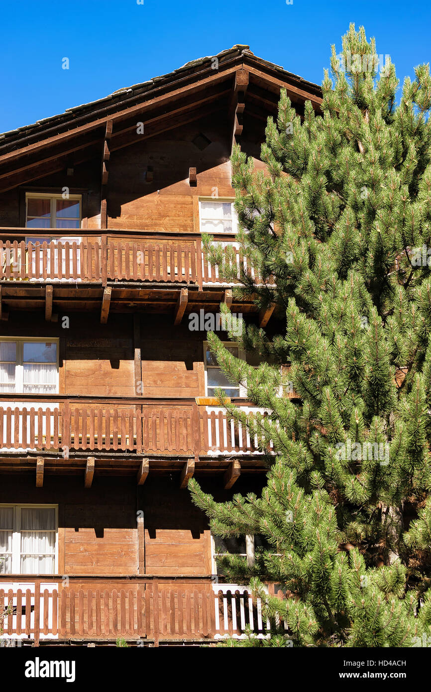 Traditional Swiss chalet with balcony in resort city Zermatt, in ...