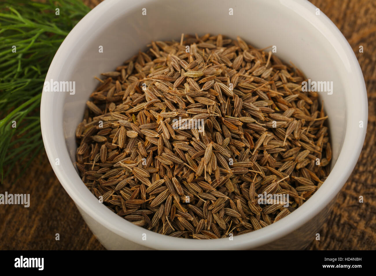 Cumin seeds heap on the wood background Stock Photo - Alamy