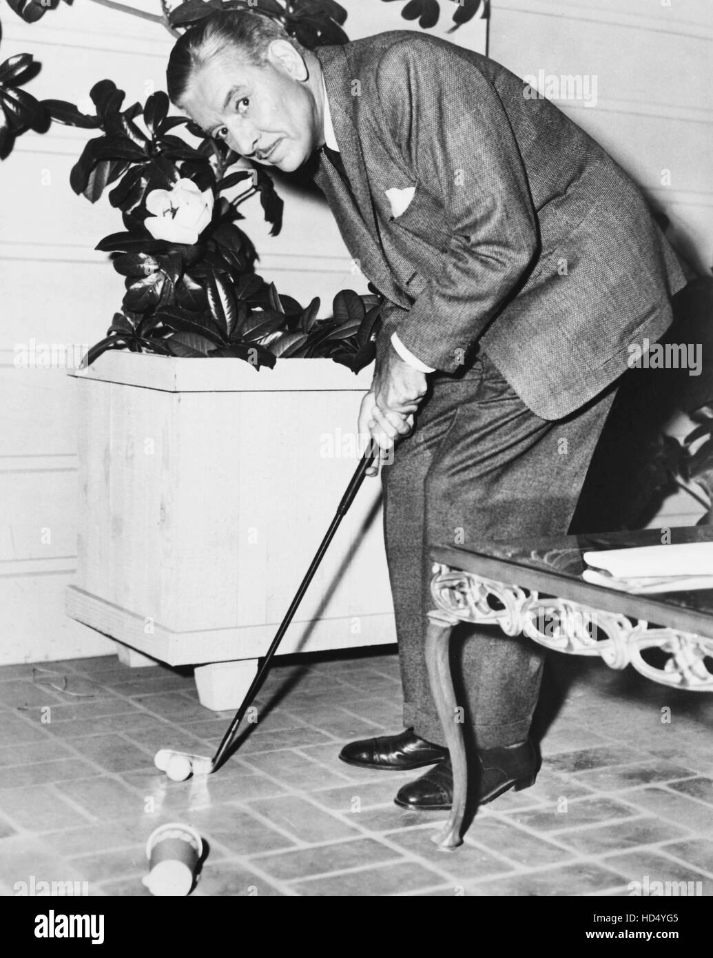 THE HALLS OF IVY, Ronald Colman, practicing his putting between scenes ...